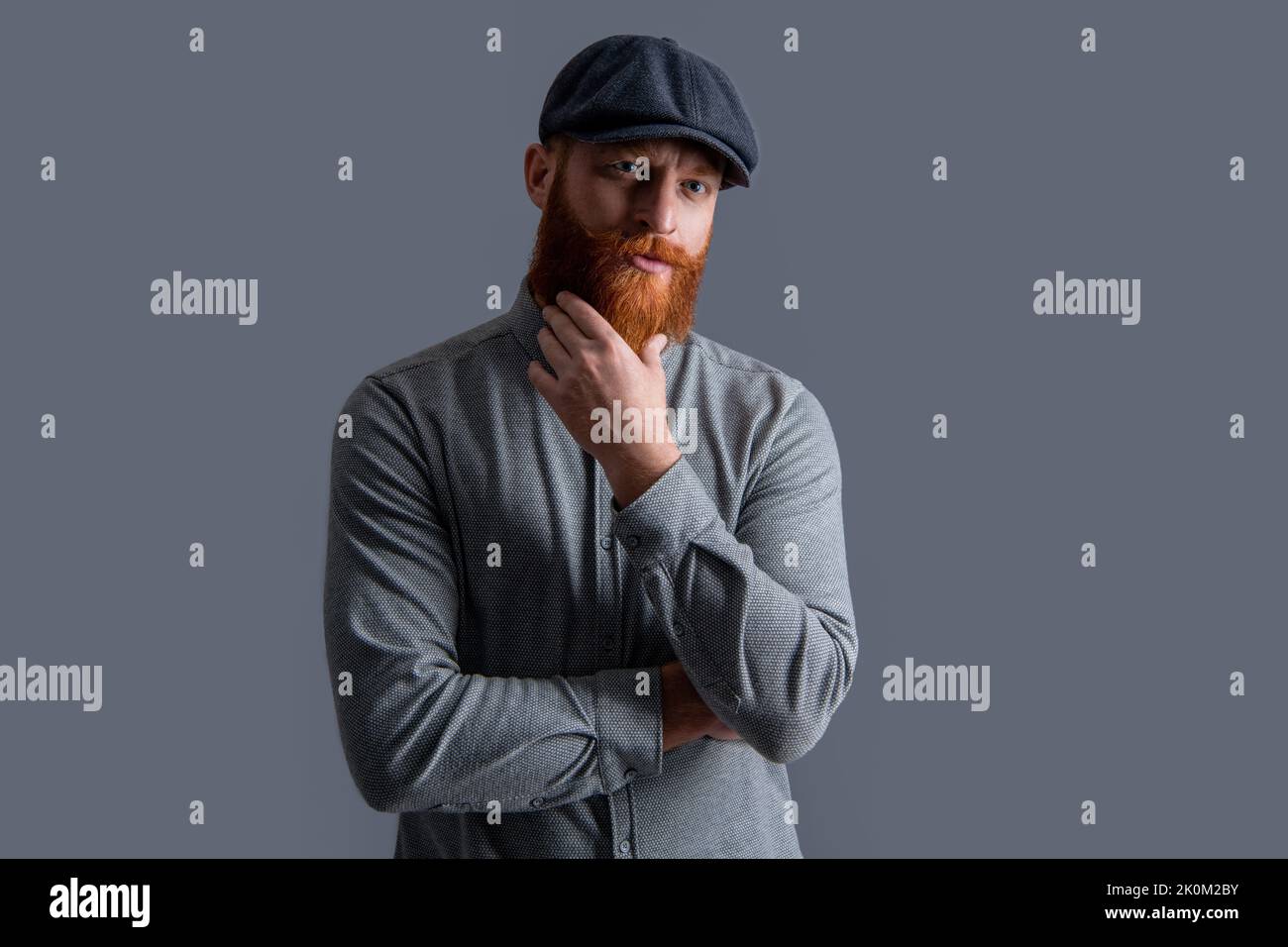 Irish guy isolated on grey. Serious guy stroking red beard. Bearded guy ...