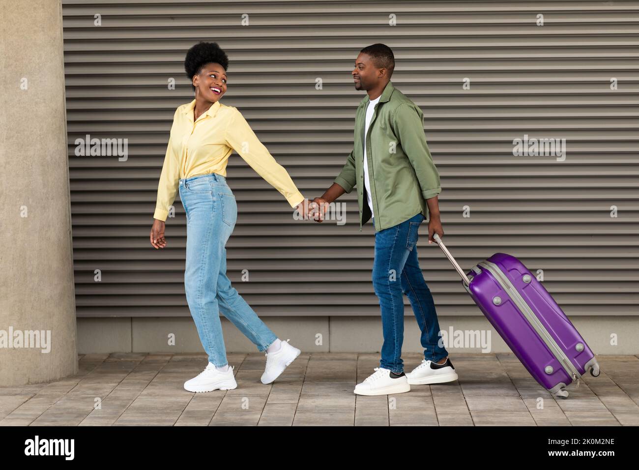 Happy African American Tourists Couple Walking With Suitcase Outdoors ... Happy African American Tourists Couple Walking With Suitcase Outdoors ...