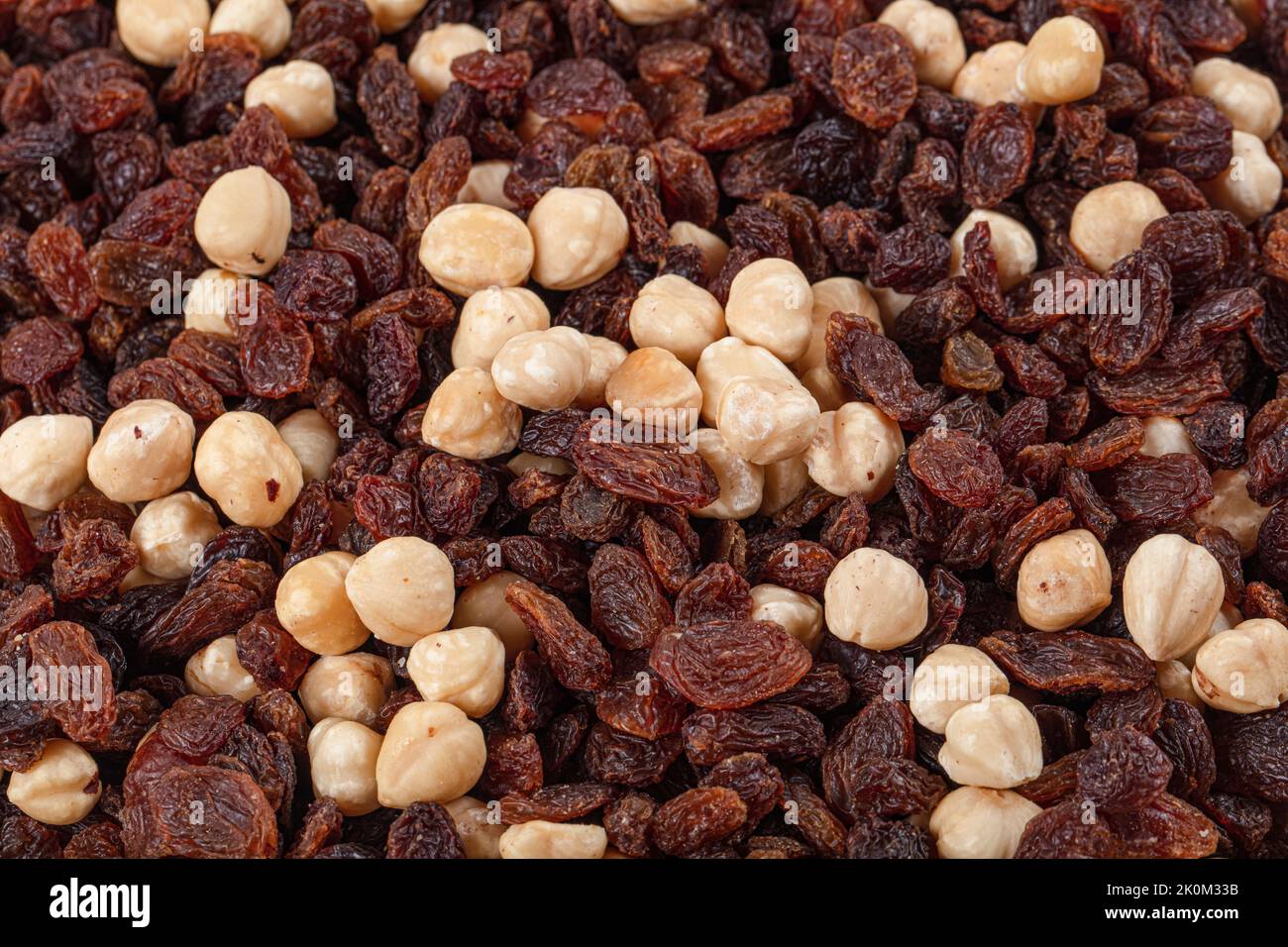Healthy food, pile of mixed nuts, hazelnut and raisins mix. Hazelnuts ...