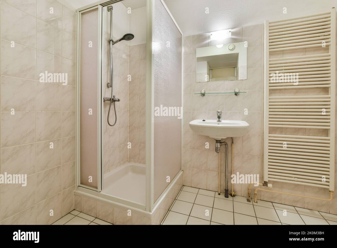 Glass partition between shower tap and wall hung toilet in modern ...