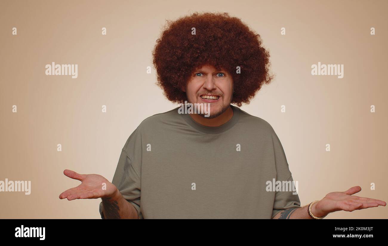 What Why. Sincere irritated adult man raising hands in indignant ...