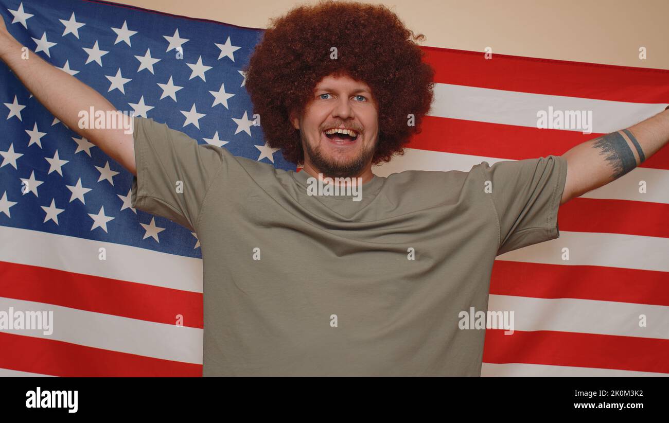 Handsome bearded man with lush hairstyle waving and wrapping in ...