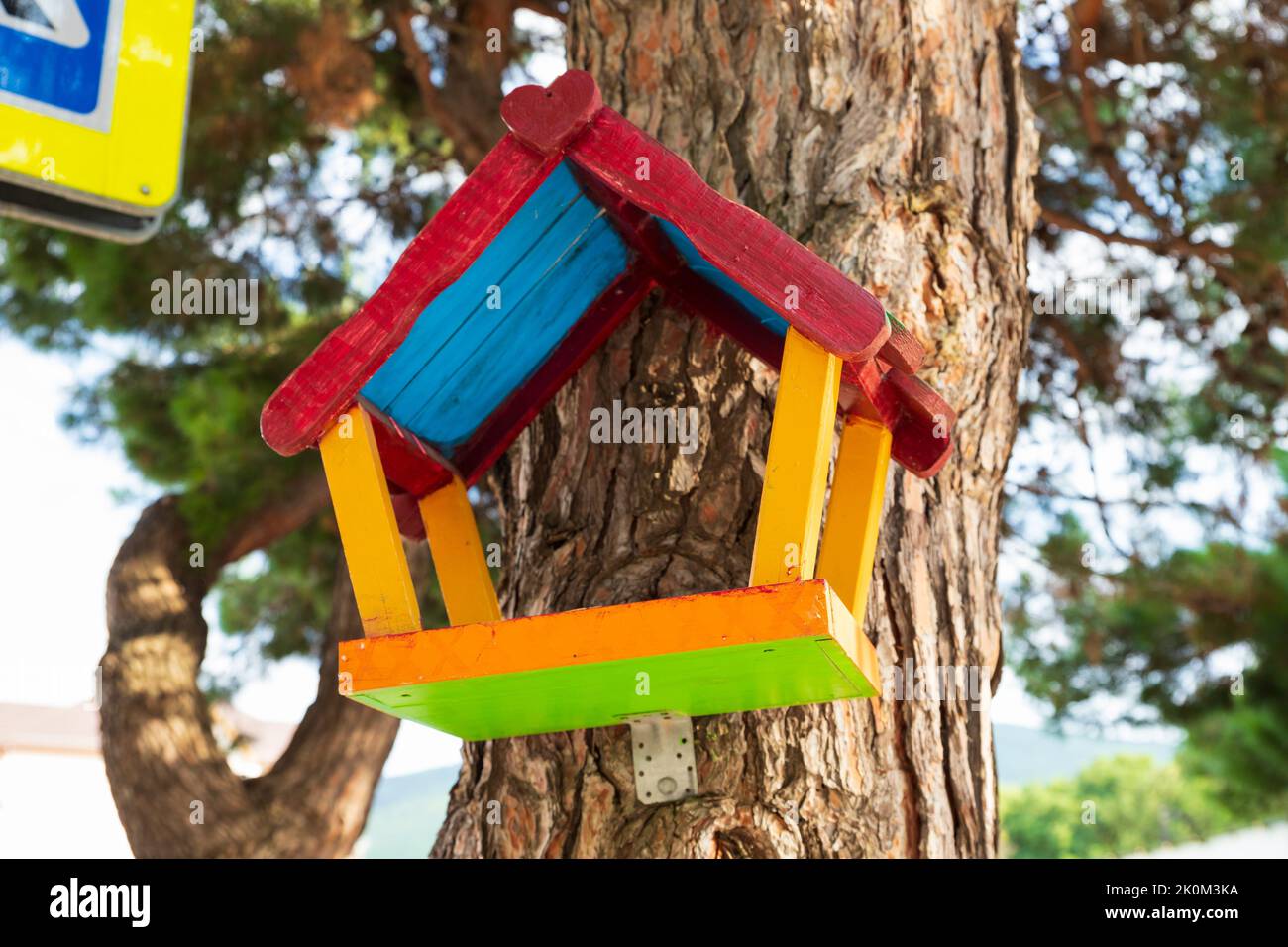Bright multicolored Wooden bird house feeder on tree Stock Photo - Alamy