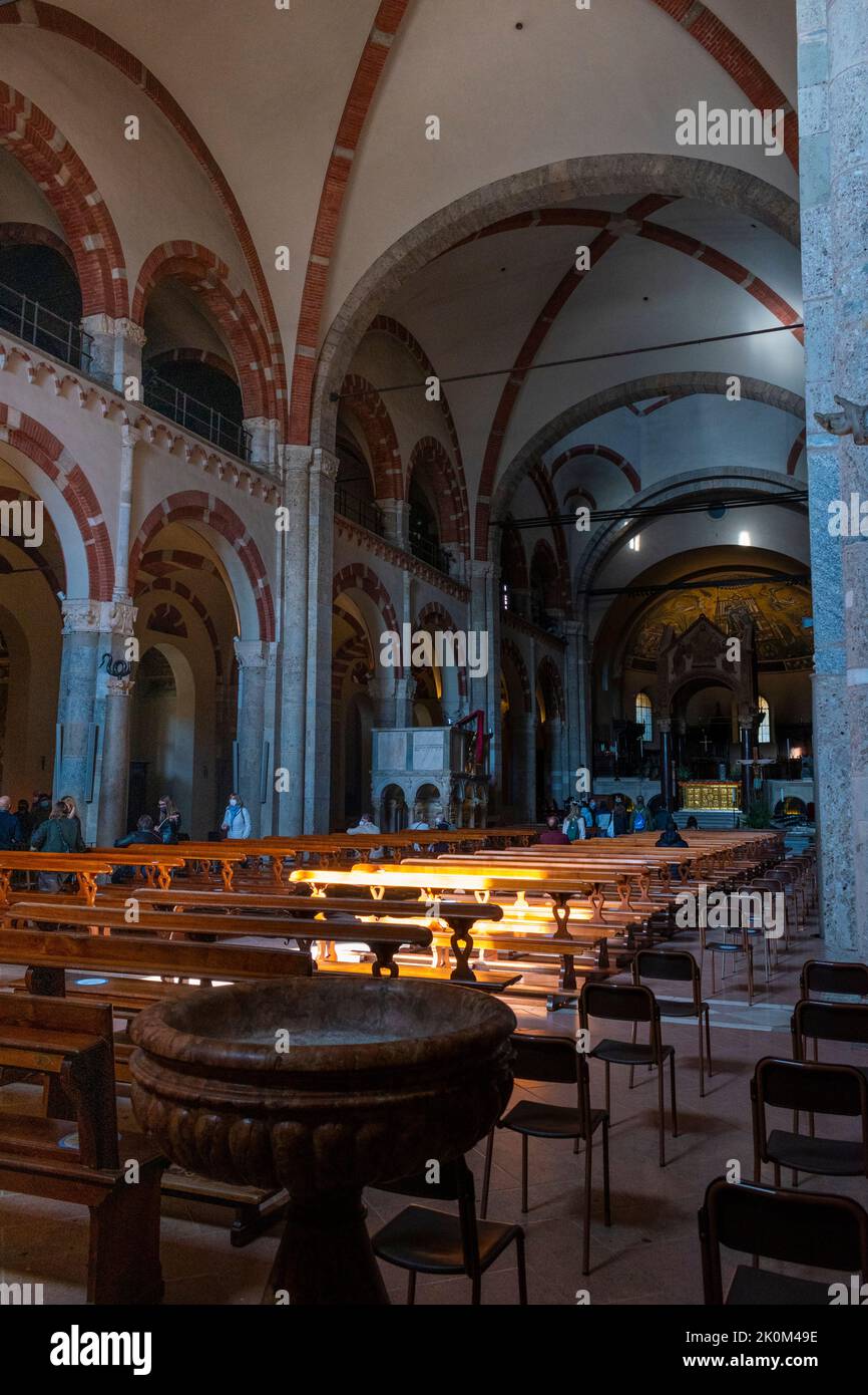 Interior of the Basilica of Saint Ambrose with the benches illuminated ...