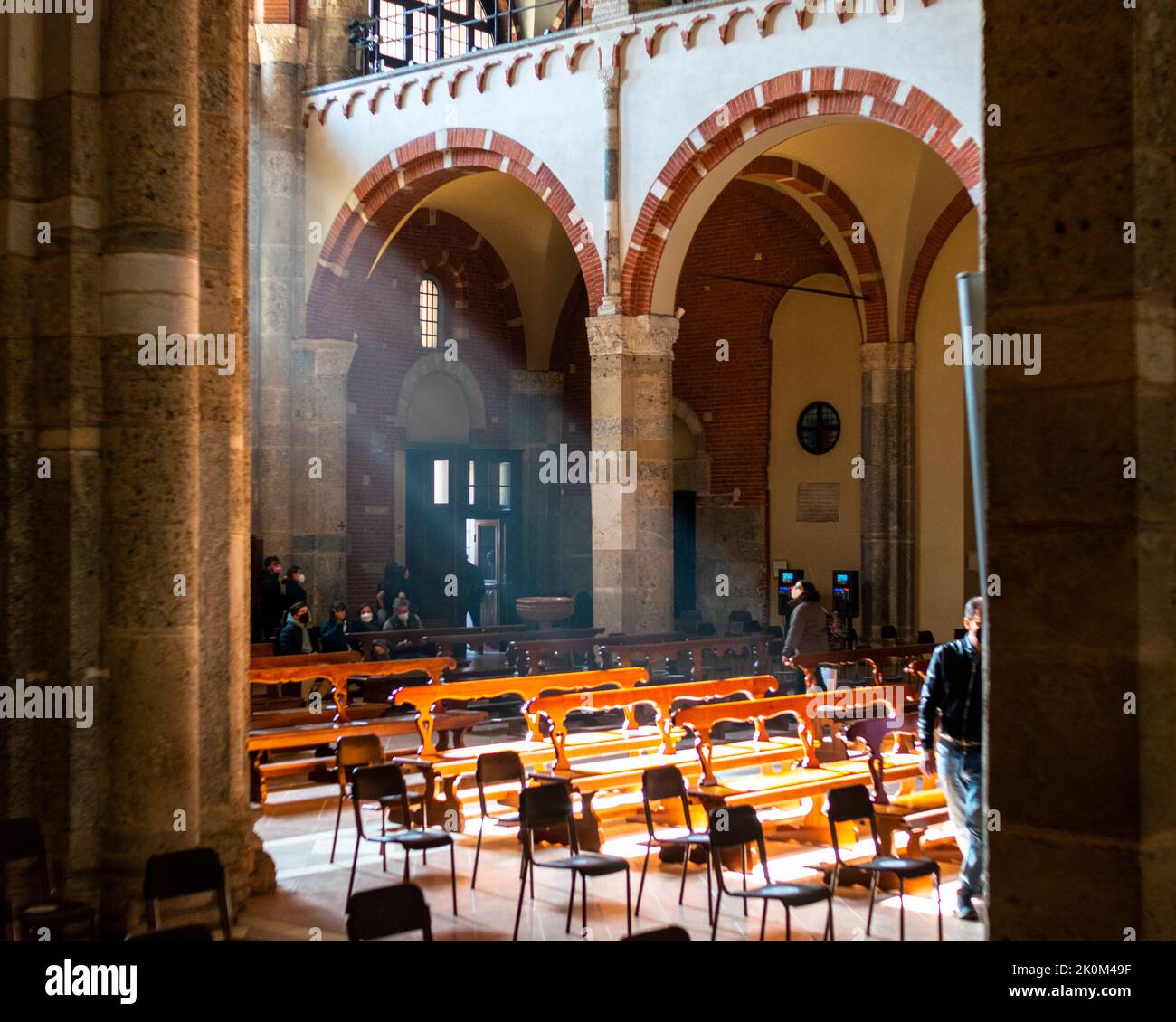 Interior of the Basilica of Saint Ambrose with the benches illuminated ...