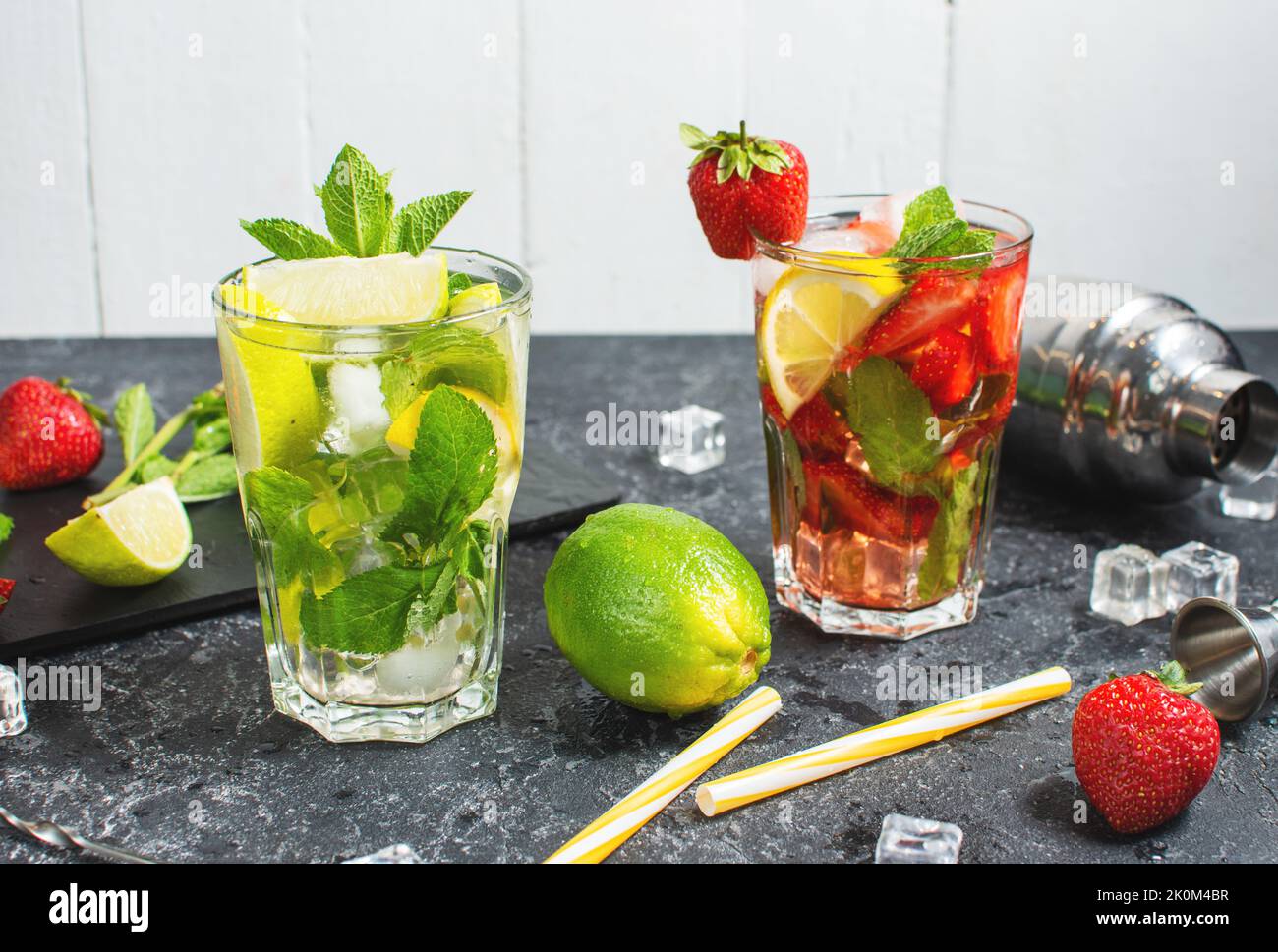 Fresh Mojito cocktail set with lime, mint, strawberry and ice in glass ...