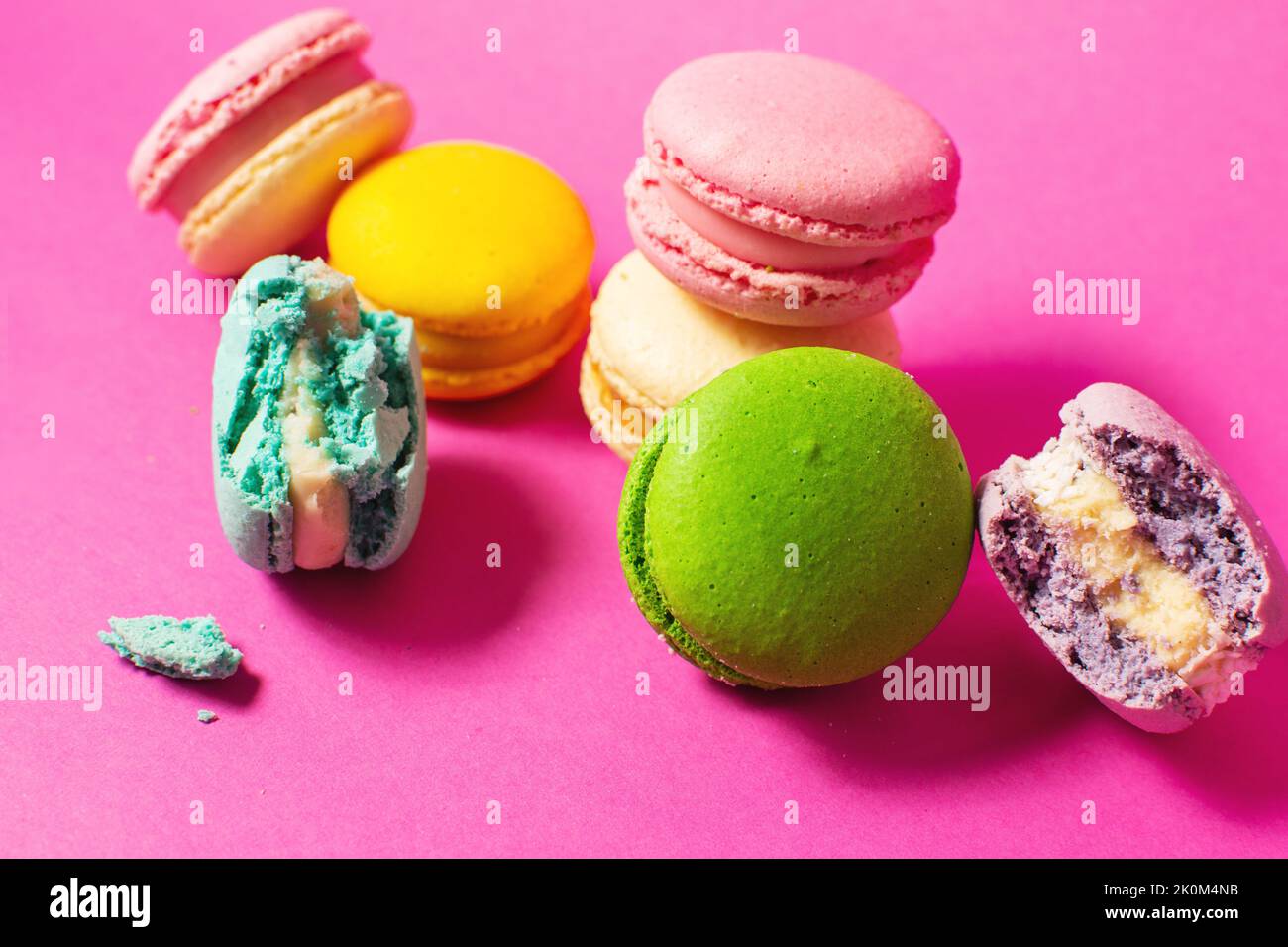 Bright colorful various flavor macarons sweet cookies on high-colored ...