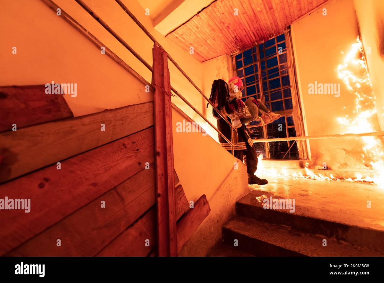 Brave Fireman Descends Stairs of a Burning Building and Holds Saved ...