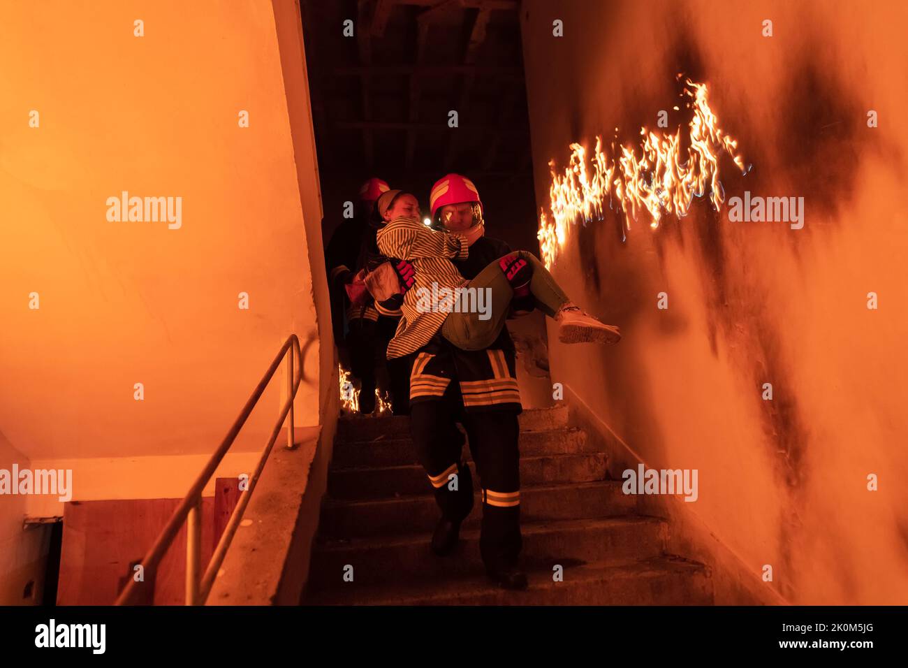 Brave Fireman Descends Stairs of a Burning Building and Holds Saved ...