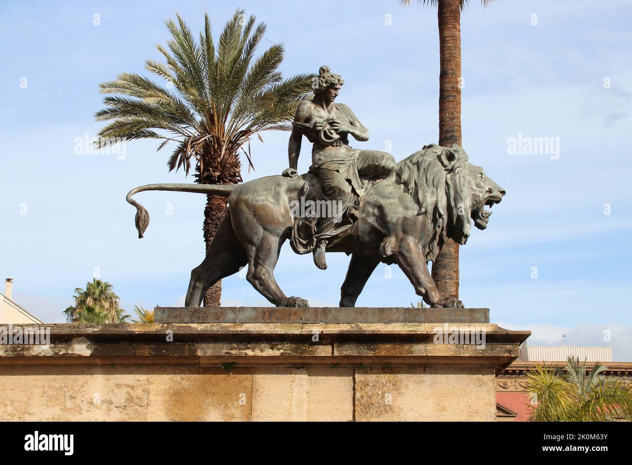 statue of a lion with a mythological character in front the massiomo ...