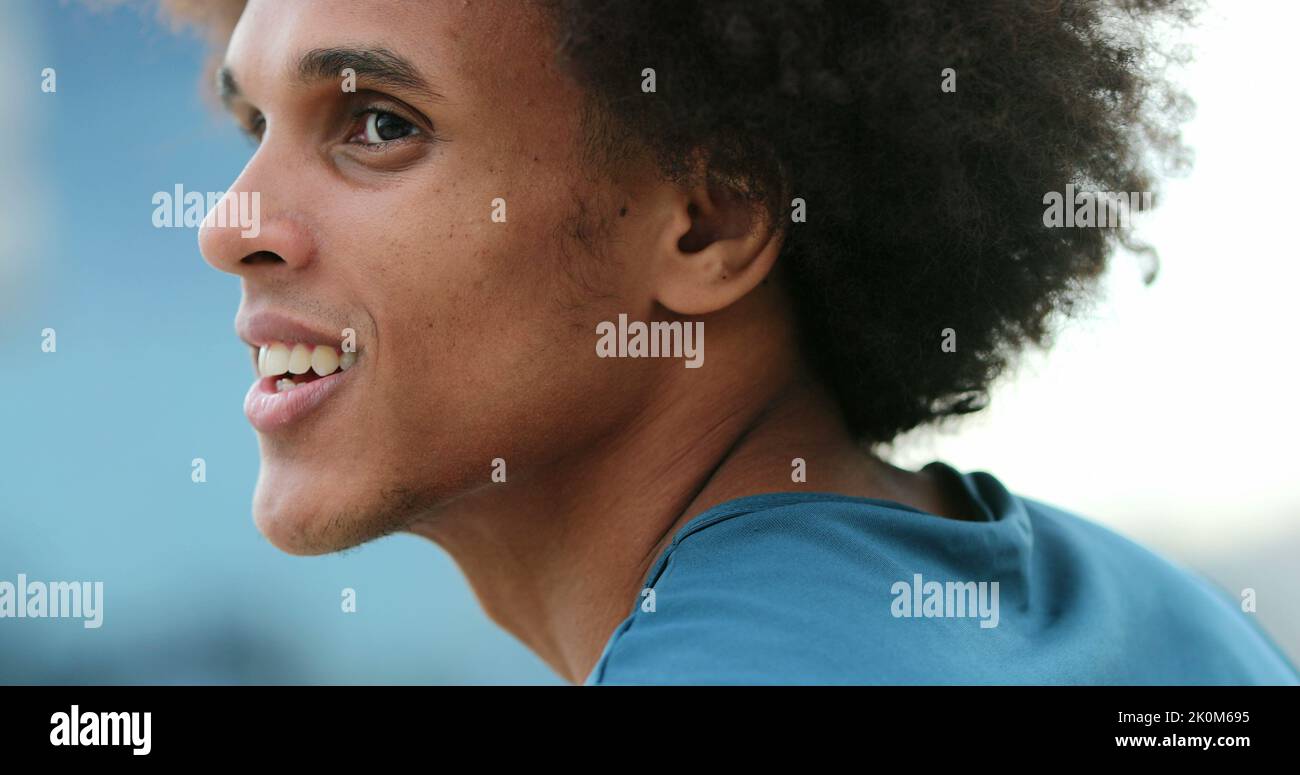 Handsome young mixed race black african man smiling and feeling happy ...