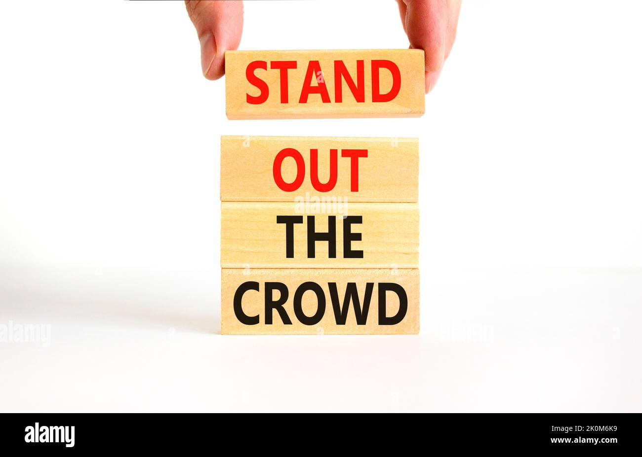 Stand out the crowd symbol. Concept words Stand out the crowd on wooden ...