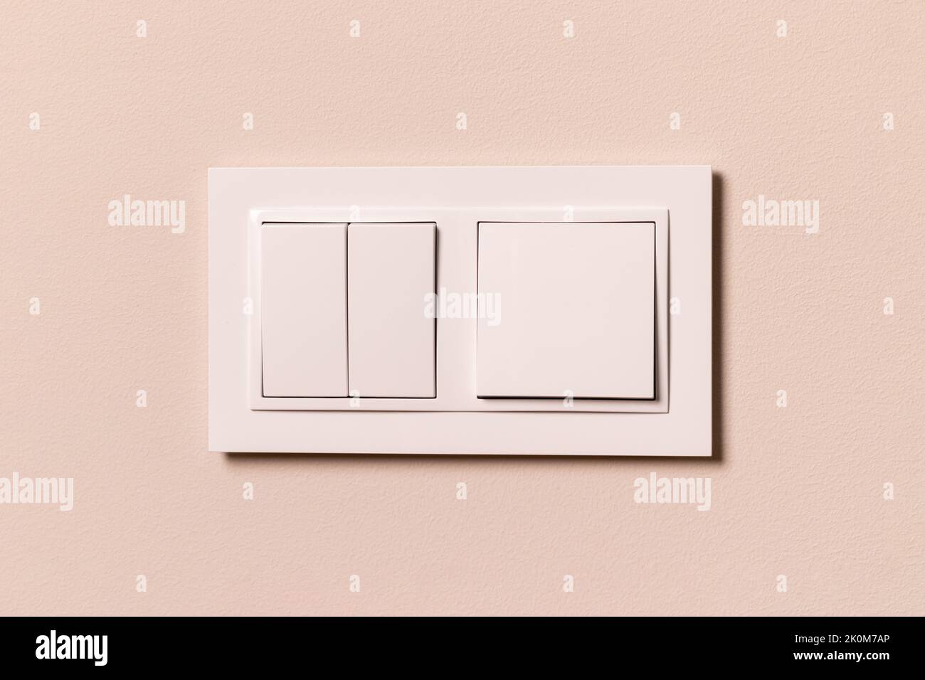 Group of white electrical switches on modern beige wall Stock Photo - Alamy