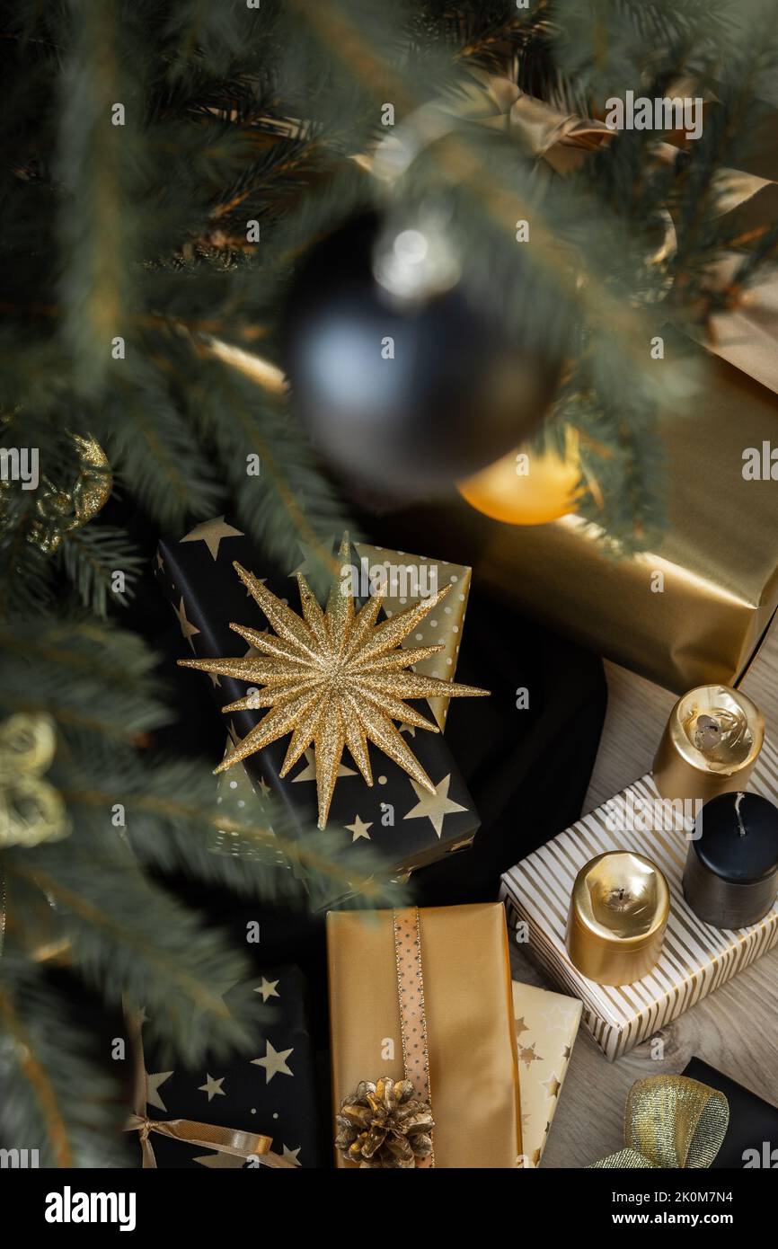 Black and gold gift boxes with bows under the Christmas tree, Merry ...