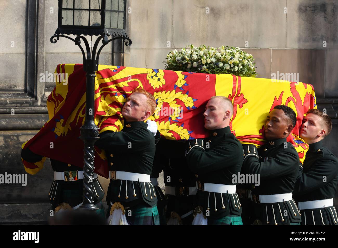 Royal guards carry Queen Elizabeth II's coffin as it arrives at St ...