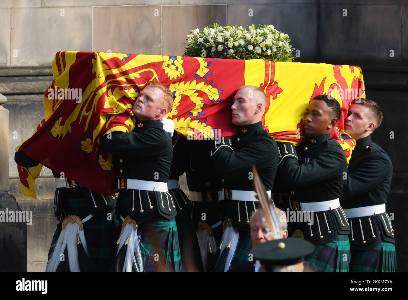 Royal guards carry Queen Elizabeth II's coffin as it arrives at St ...