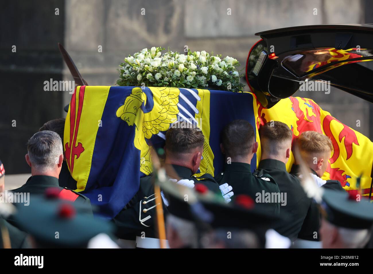 Royal guards carry Queen Elizabeth II's coffin as it arrives at St ...