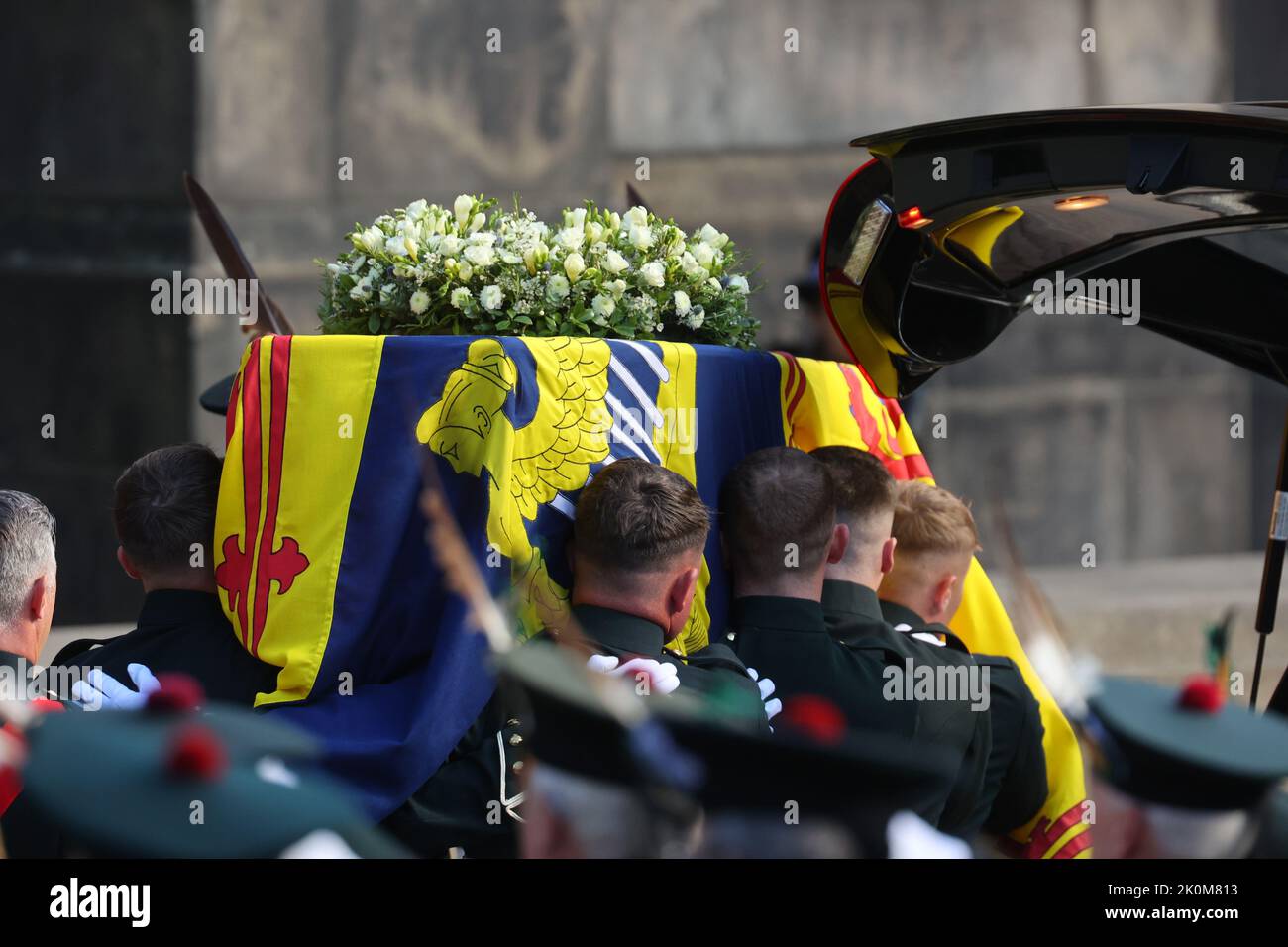 Royal guards carry Queen Elizabeth II's coffin as it arrives at St ...