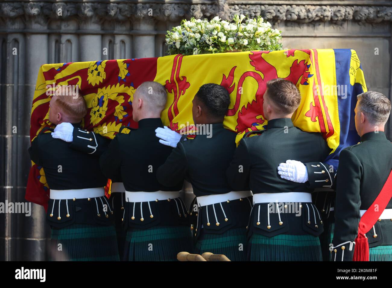 Royal guards carry Queen Elizabeth II's coffin as it arrives at St ...