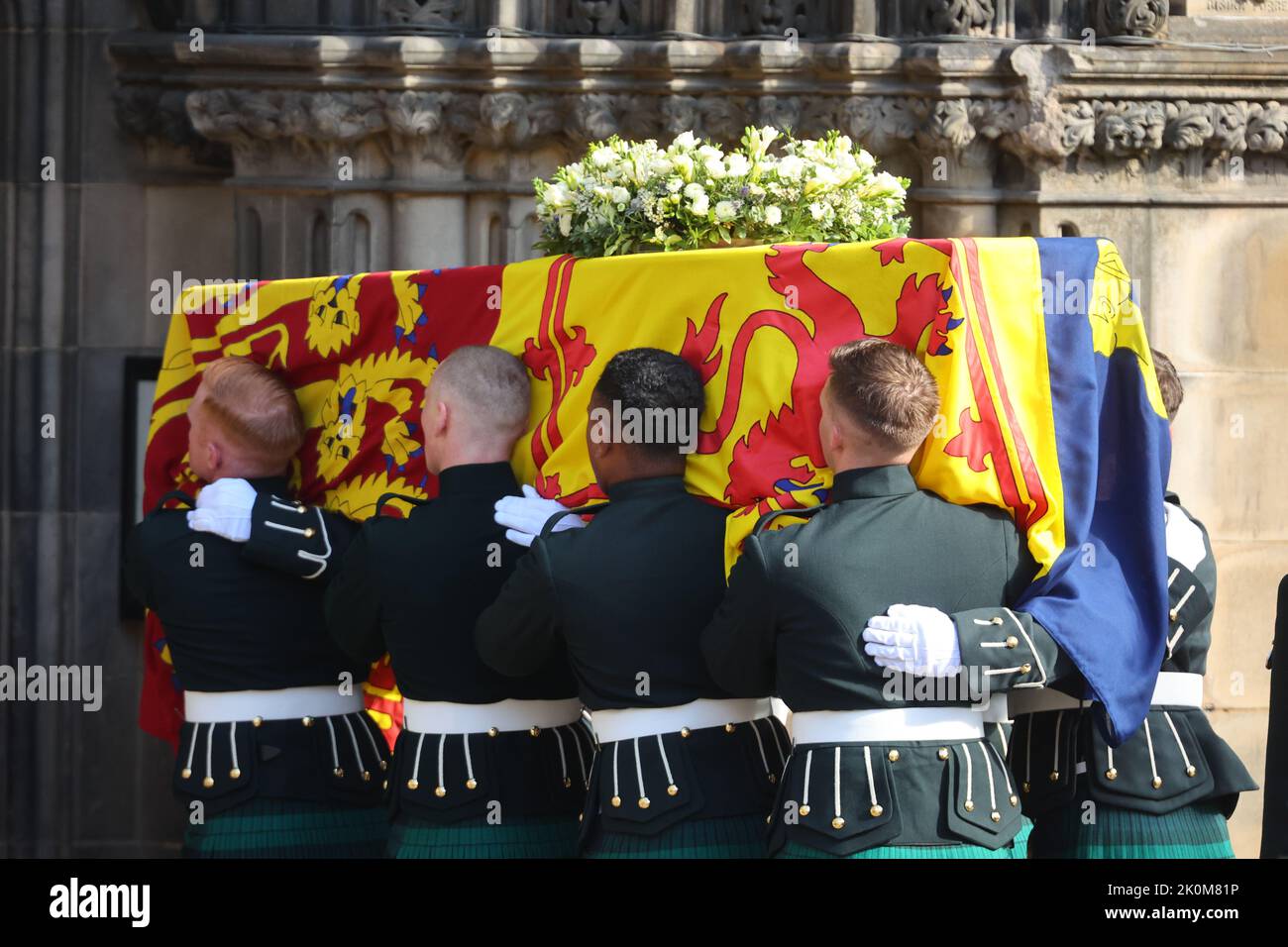 Royal guards carry Queen Elizabeth II's coffin as it arrives at St ...