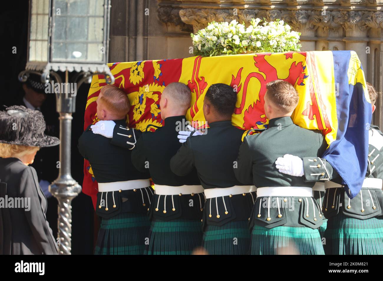 The Queen Consort (left) watches as royal guards carry Queen Elizabeth ...