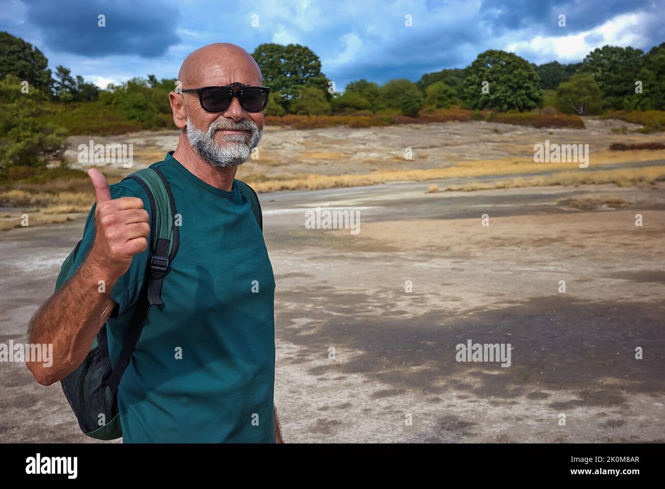 Hiker visits the caldera, a small circular crater with a marsh of ...