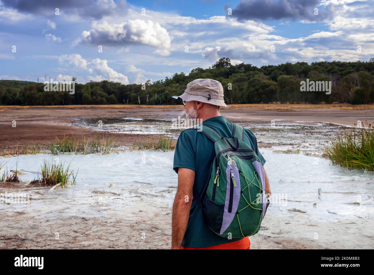 Hiker visits the caldera, a small circular crater with a marsh of ...