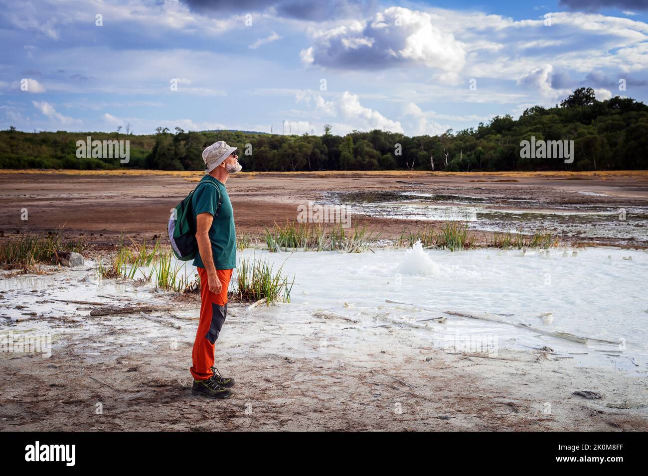 Hiker visits the caldera, a small circular crater with a marsh of ...
