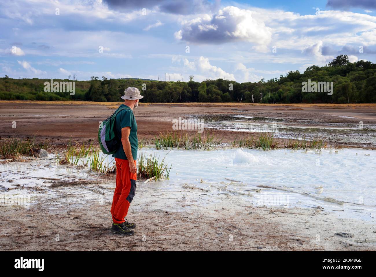 Hiker visits the caldera, a small circular crater with a marsh of ...