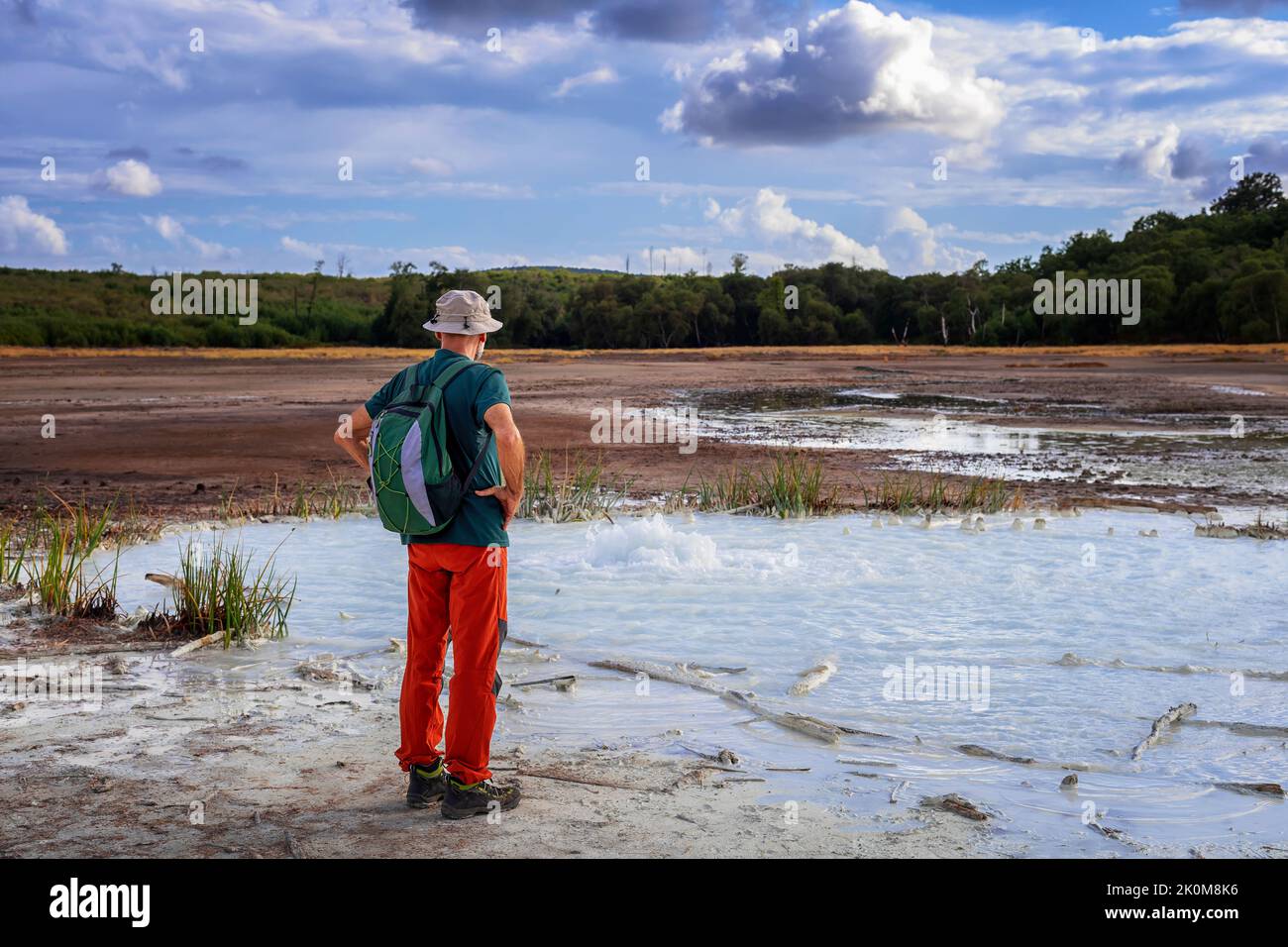 Hiker visits the caldera, a small circular crater with a marsh of ...