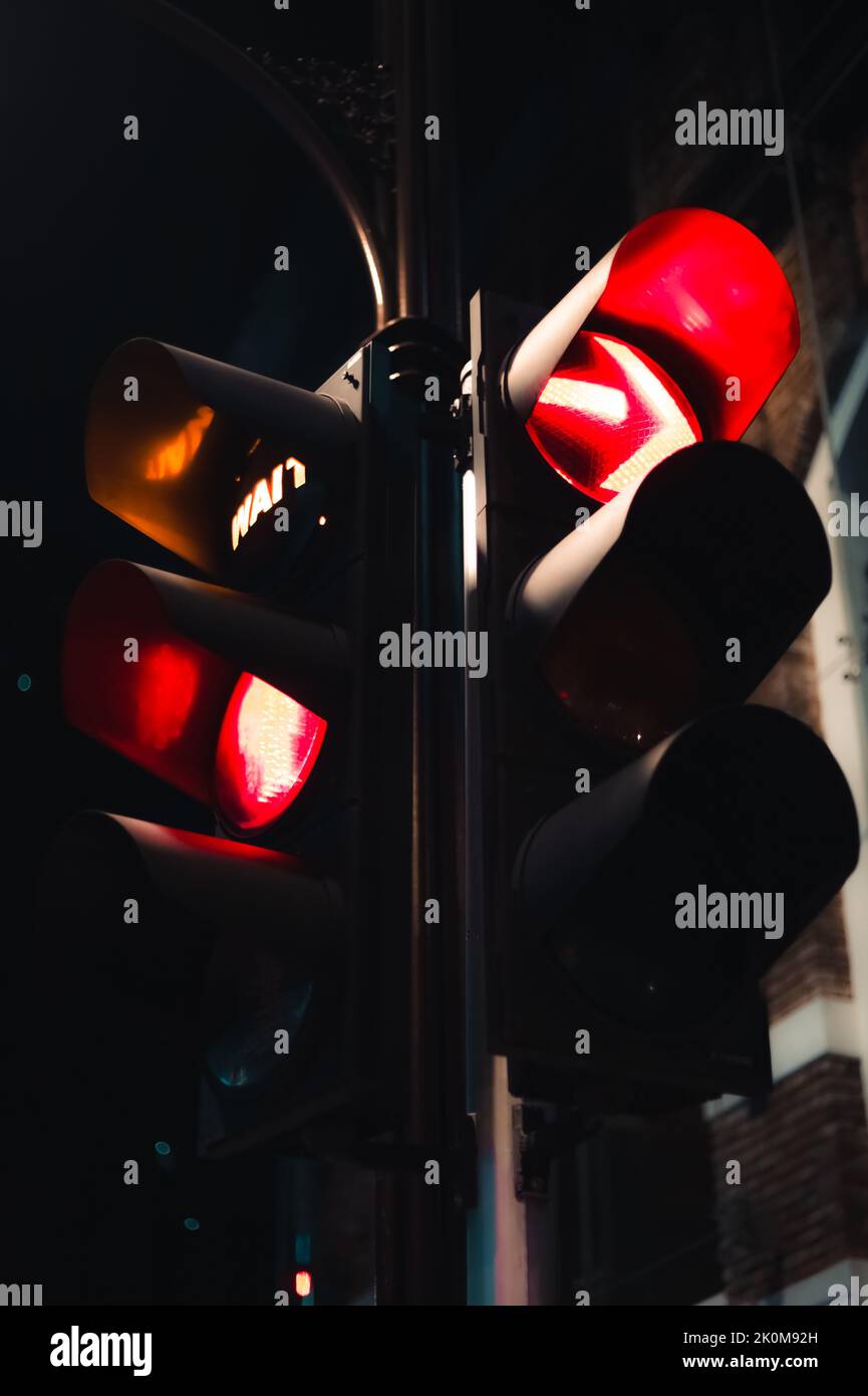 A vertical closeup of traffic lights during nighttime Stock Photo - Alamy