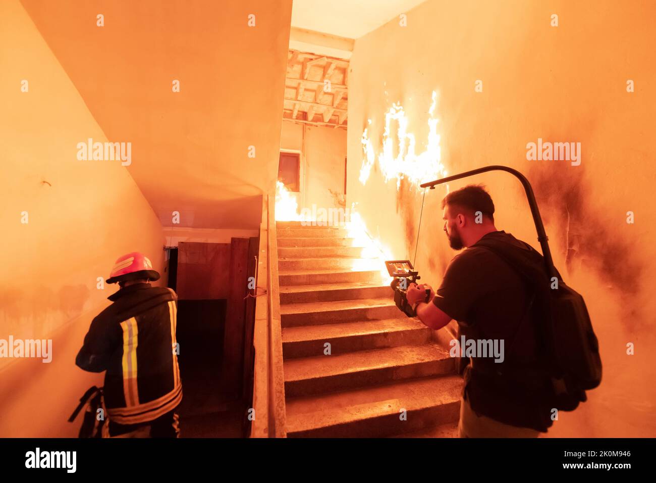 Brave Fireman Descends Stairs of a Burning Building and Holds Saved ...