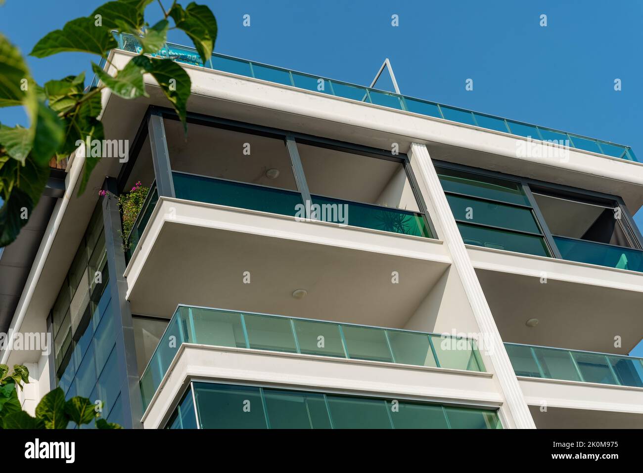 Image of the exterior of a residential building against a blue sky ...