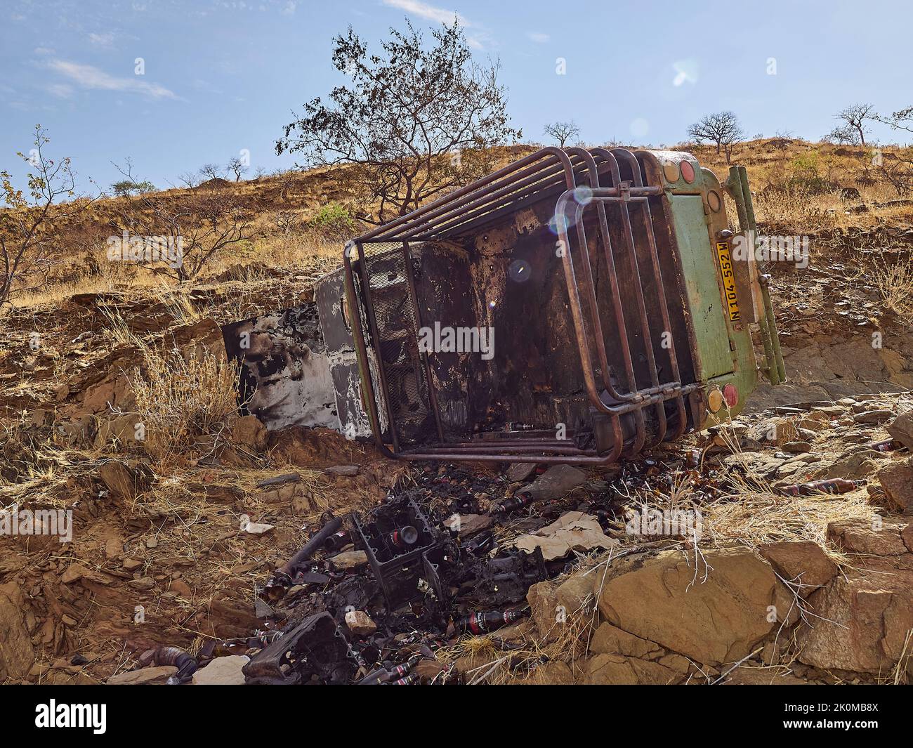 burnt out car wreck lying on its side on steep Jan Joubert mountain ...