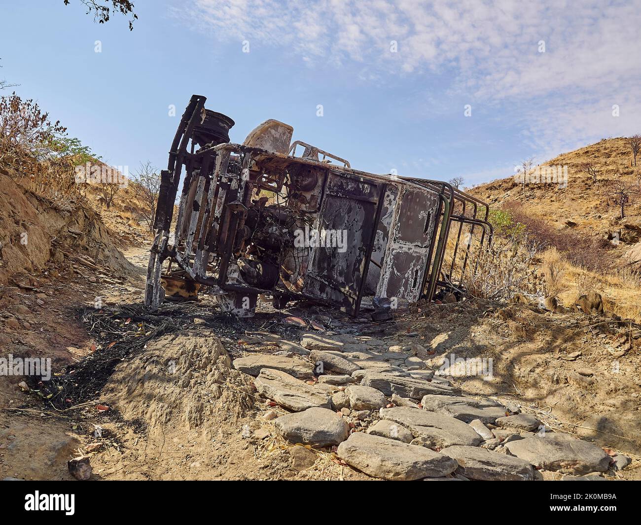 burnt out car wreck lying on its side on steep Jan Joubert mountain ...