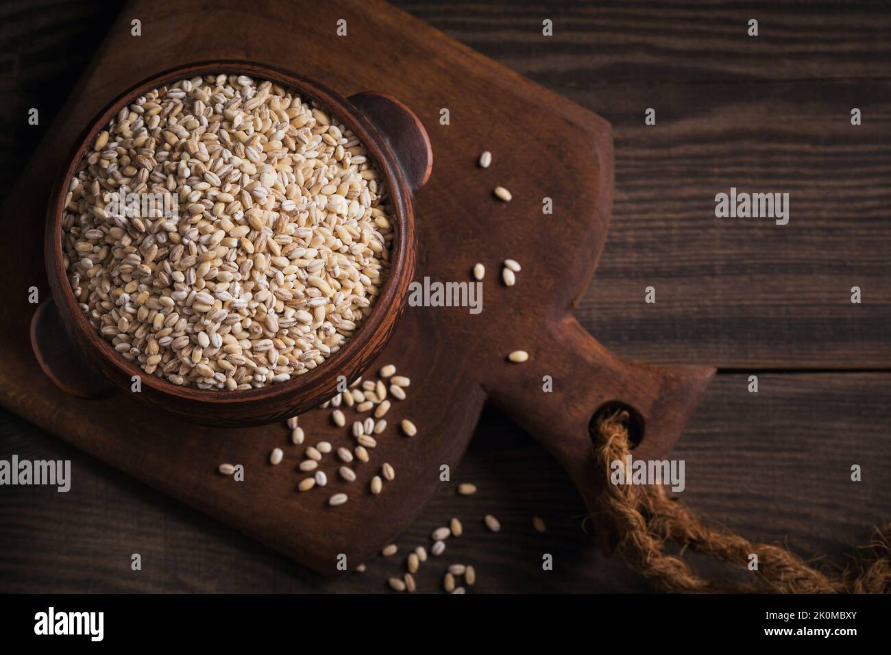 Organic uncooked dried barley cereal grain in a bowl Stock Photo - Alamy