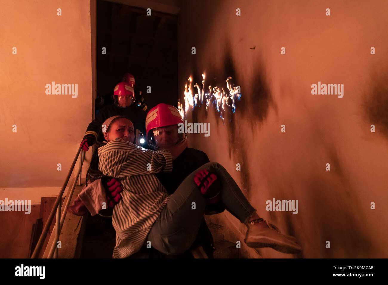 Brave Fireman Descends Stairs of a Burning Building and Holds Saved ...