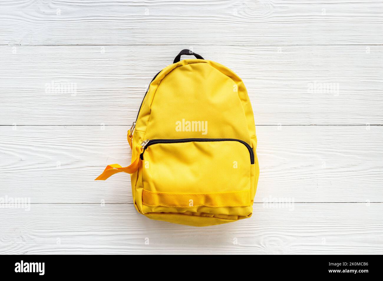 Classic yellow school backpack top view. Educational objects background ...