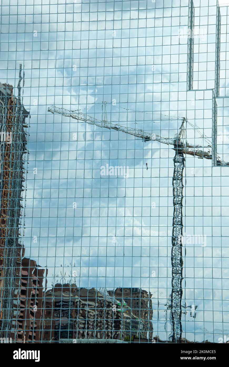Tall Glass Office Building with Reflection of Construction Crane ...