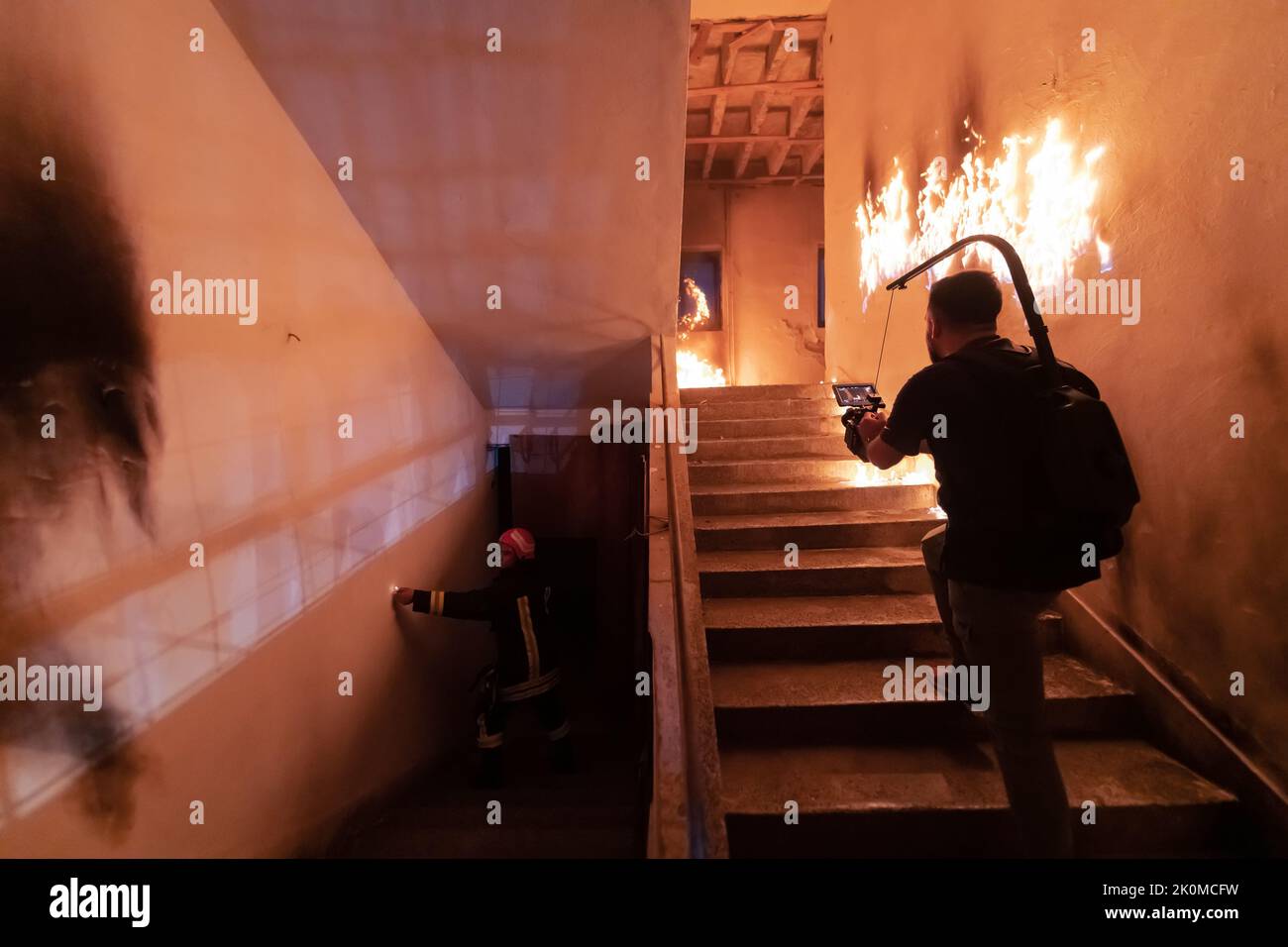 Brave Fireman Descends Stairs of a Burning Building and Holds Saved ...