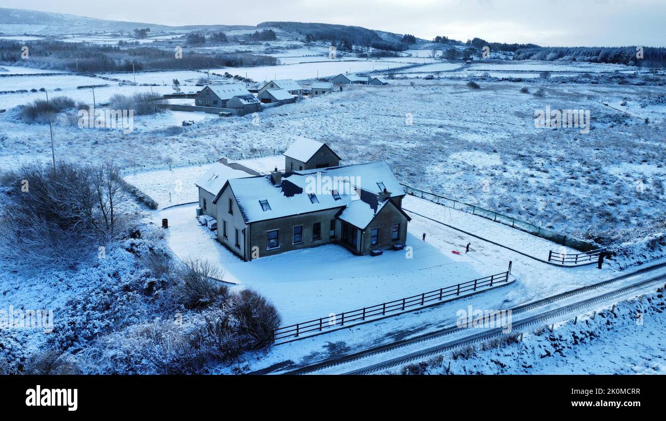 The winter landscape with rural buildings covered with snow ...