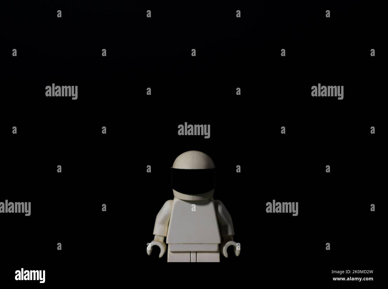 toy astronaut falling into the void in the middle of the black space ...