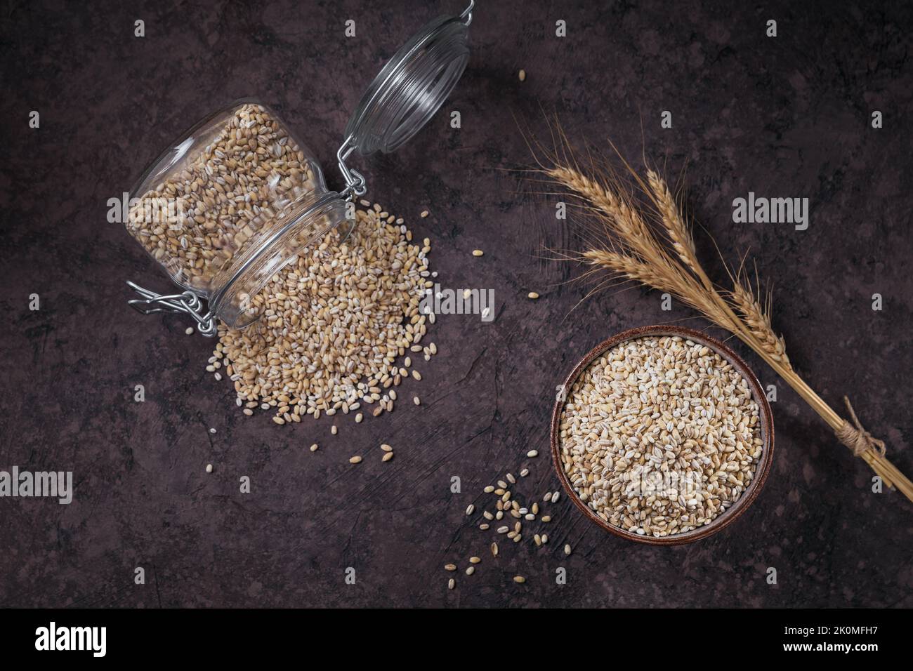 Organic uncooked dried barley cereal grain in a bowl Stock Photo - Alamy