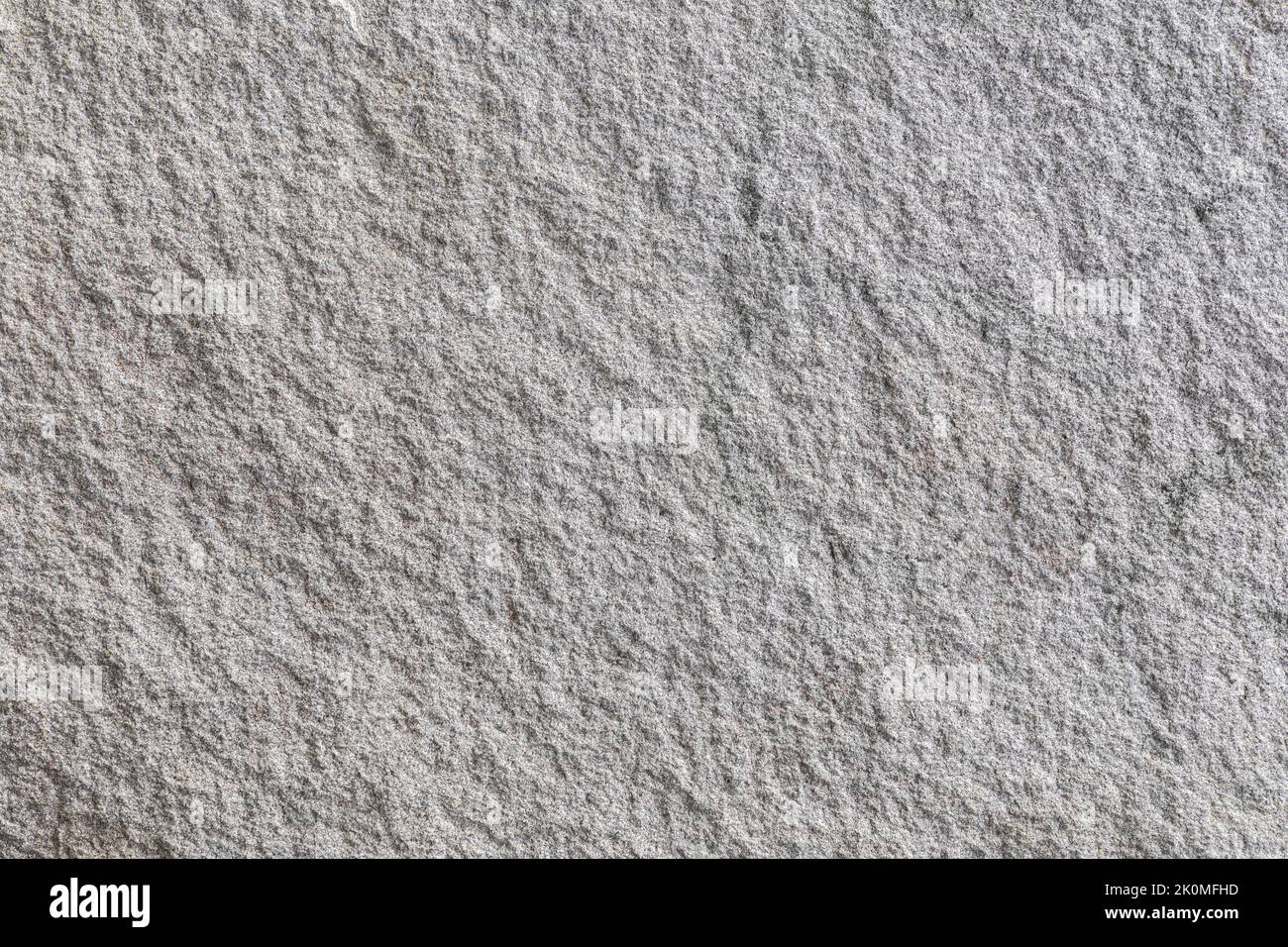 Close-up of a solid light gray granite rock surface texture, front view ...