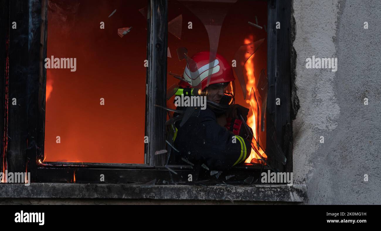 Firefighter hero carrying baby girl out from burning building area from ...