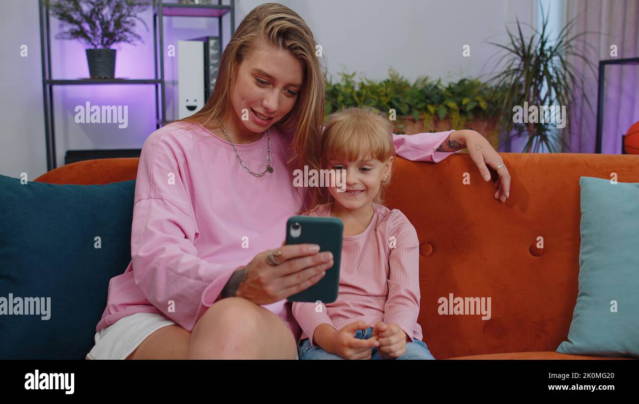 Happy family mother or nanny and child kid daughter laugh use ...