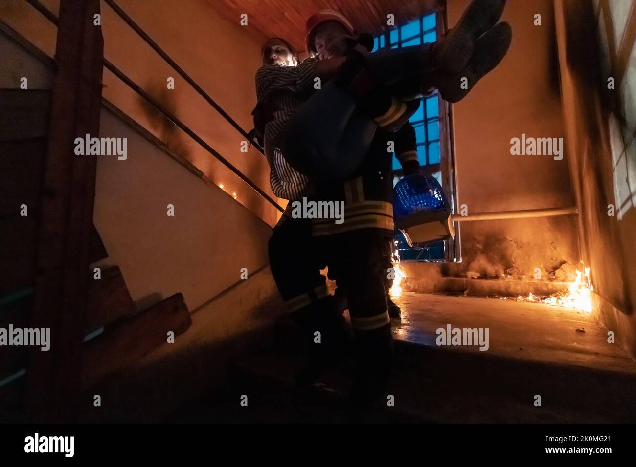 Brave Fireman Descends Stairs of a Burning Building and Holds Saved ...