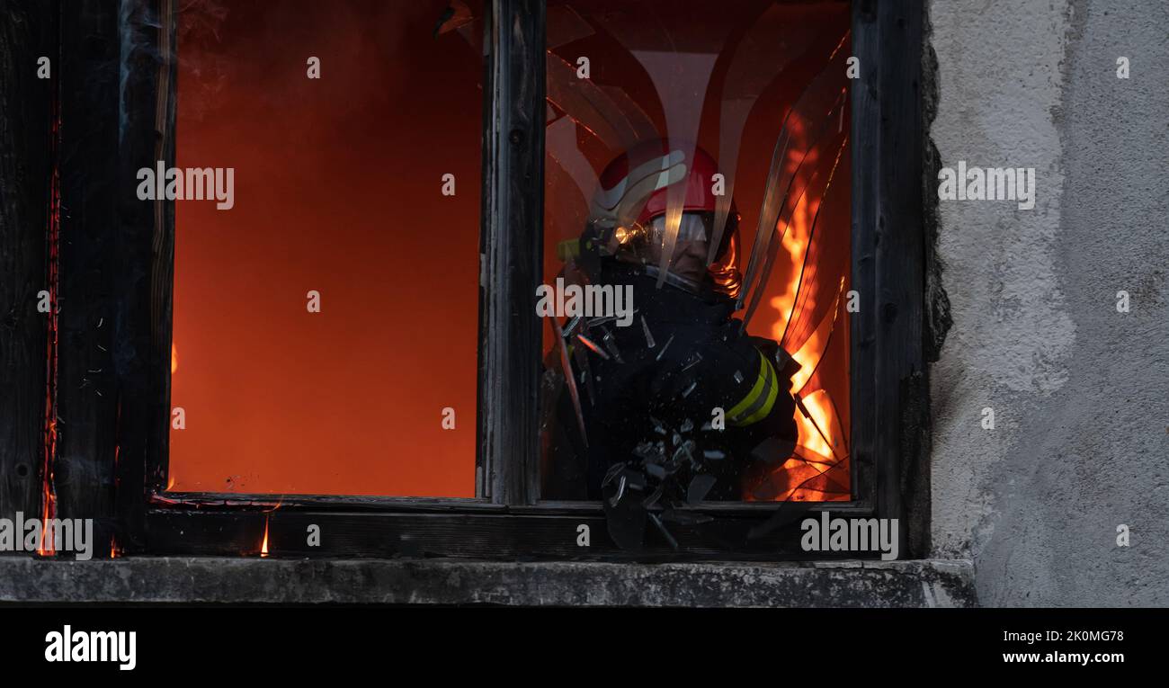 Firefighter hero carrying baby girl out from burning building area from ...
