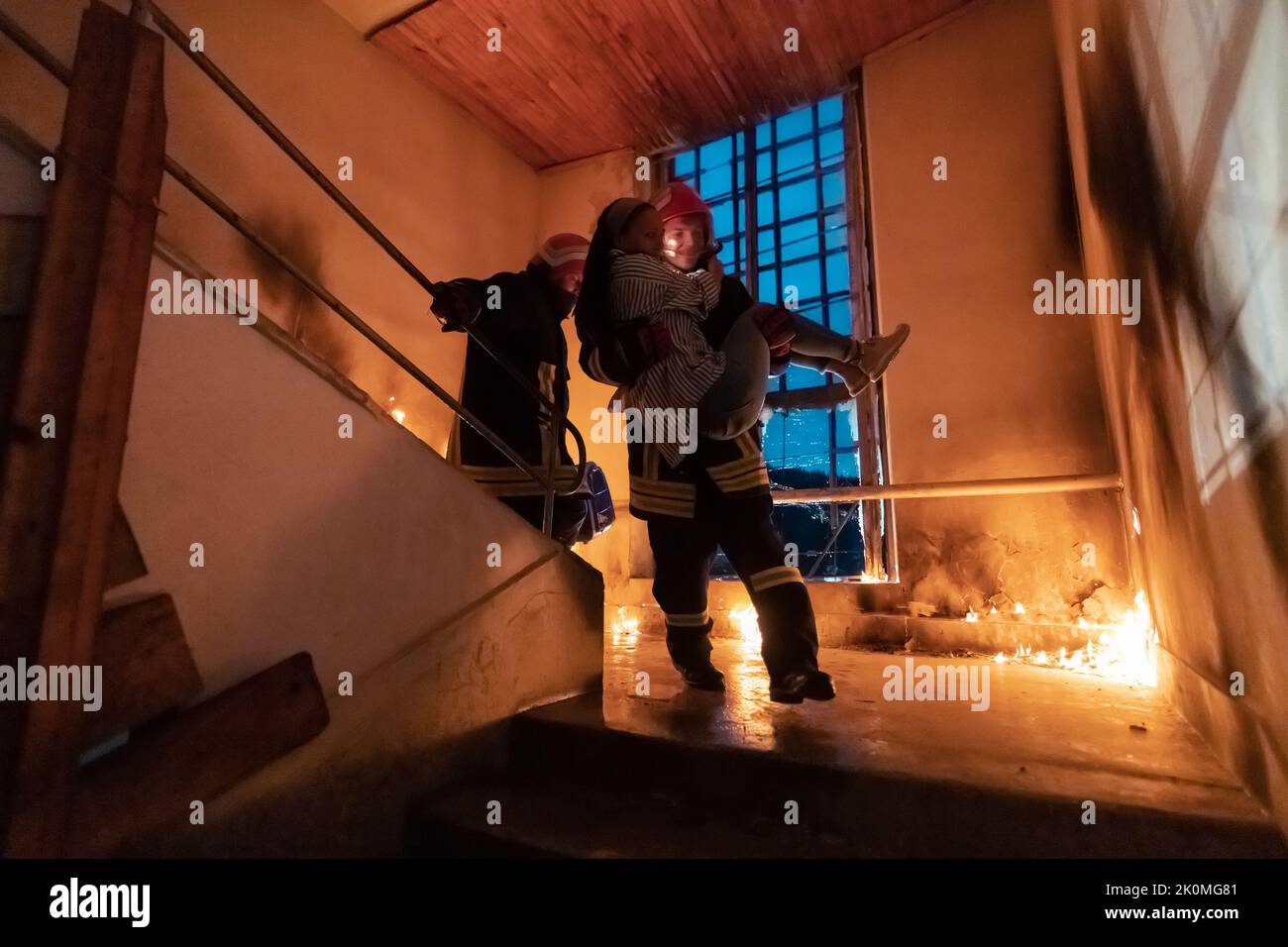 Brave Fireman Descends Stairs of a Burning Building and Holds Saved ...