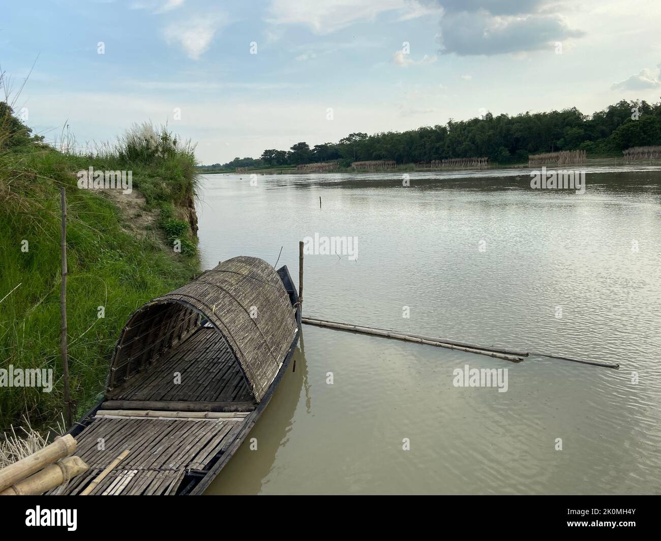 An empty bamboo boat on the river Stock Photo - Alamy